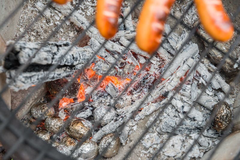 Cooking Grate with Sausages at a Old Fire Pot with Burning Fire Stock ...