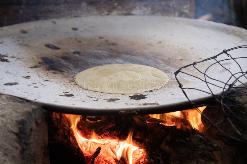 Cooking Handmade Corn Tortillas on a Traditional Comal in an Open Fire ...