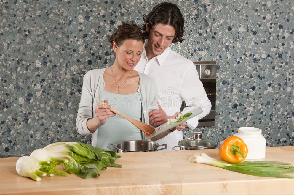 Cooking he holds her arm stock image. Image of cooking - 10552745