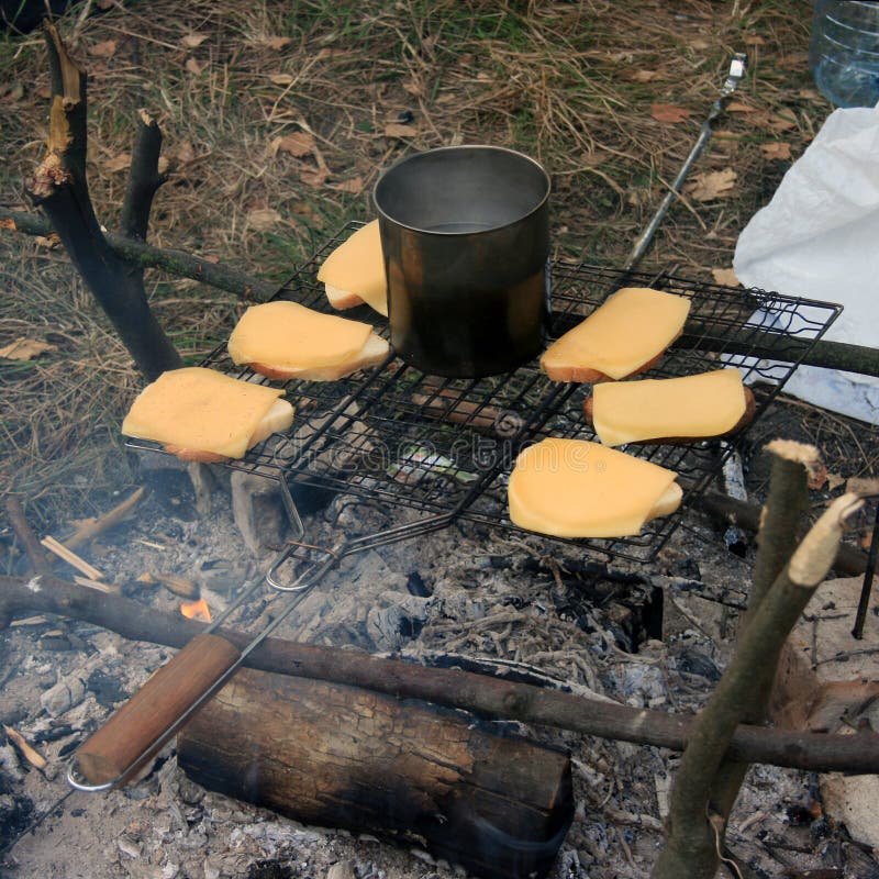Cooking Hot Cheese Sandwiches and Tea on an Open Fire in Nature. Stock ...