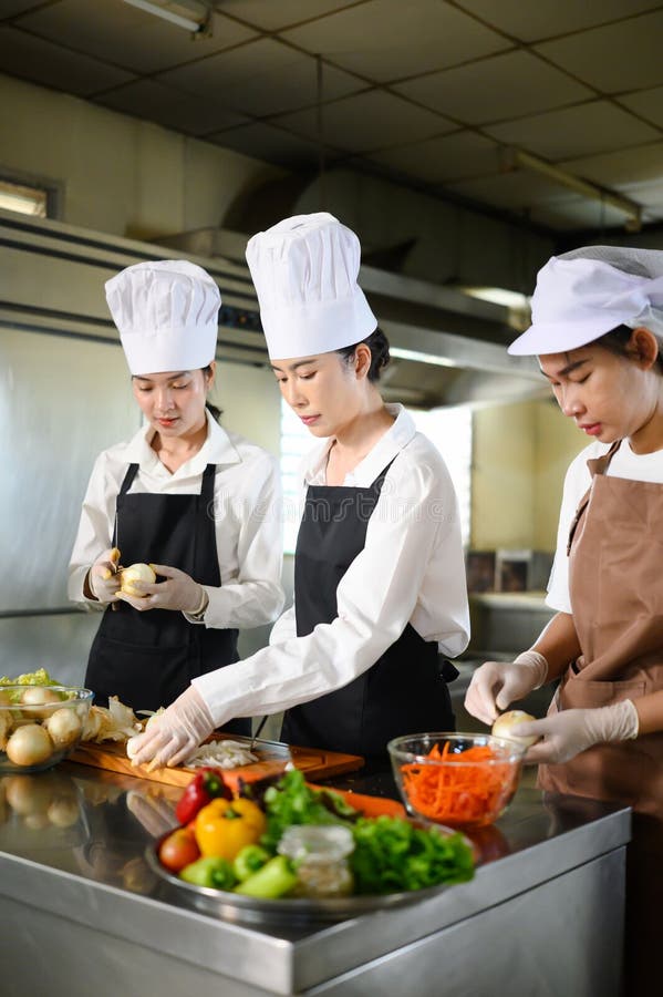 Cooking Instructor Demonstrating Slicing Techniques To Students during ...