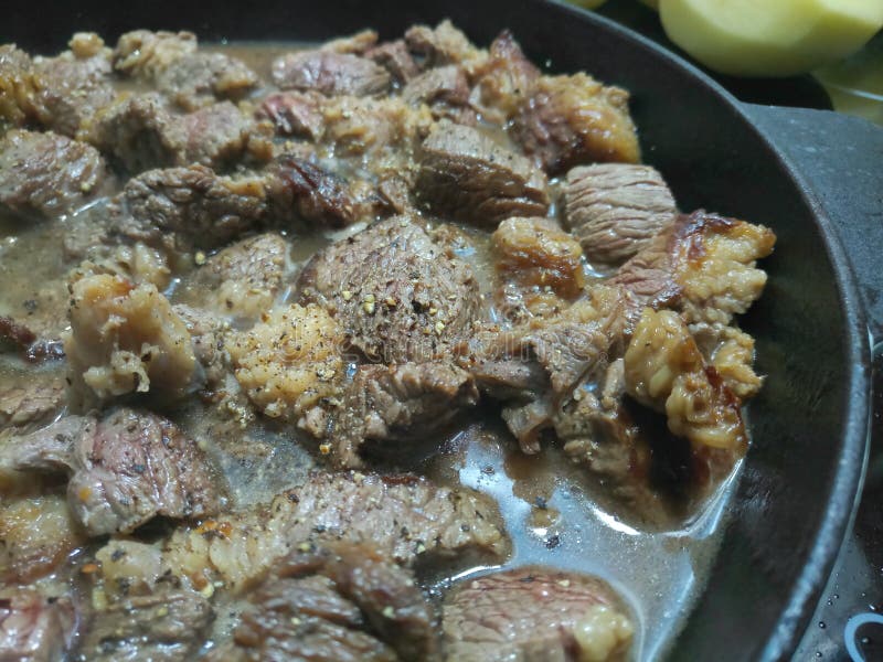 Diced Beef Cooking in an Iron Cast Pan Stock Image - Image of rising ...