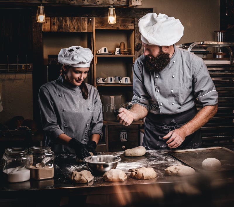 Chef Teaching His Assistant To Bake the Bread in a Bakery. Stock Image ...