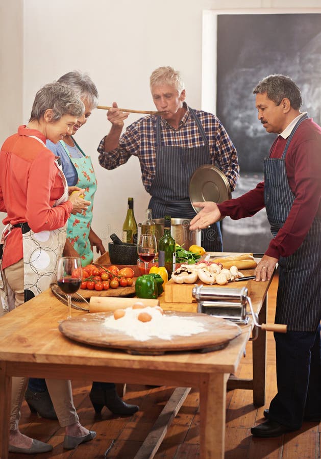Cooking is Love You Can Taste. a Group of Seniors Cooking in the ...