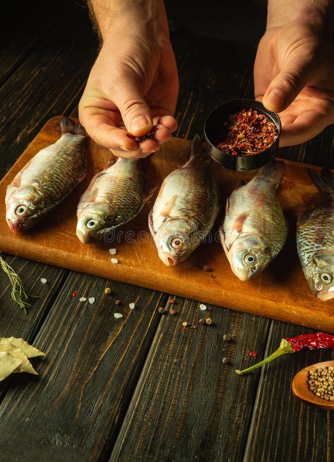 Cooking Marinated Fish with Aromatic Spices by the Hands of a Chef on a ...