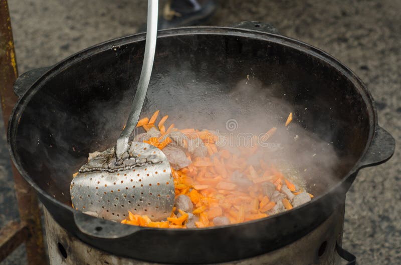 Cooking Meat Outdoors in Cast-iron Cauldron. Stock Photo - Image of ...