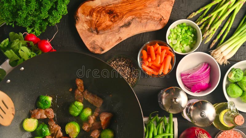 Cooking Meat with Vegetables, in a Wok, on a Background with Vegetables ...