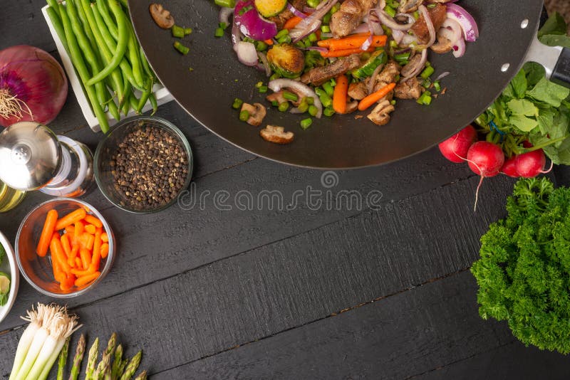 Cooking Meat with Vegetables on a Wok, on the Background of Vegetables ...