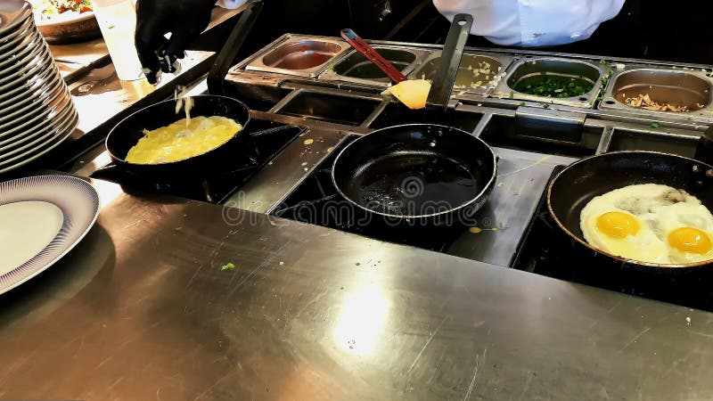 Cooking Omelettes and Fried Eggs. Breakfast Buffet in Restaurant Stock ...