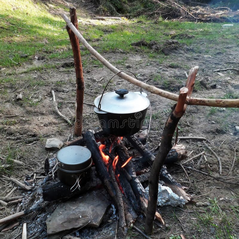 Cooking over a campfire stock photo. Image of outdoor - 57980150