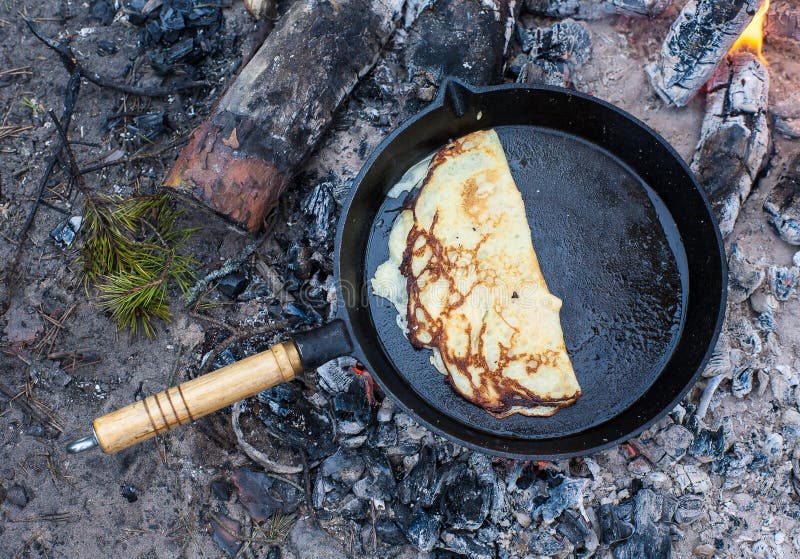 Cooking Pancakes on the Fire in the Forest. Stock Image - Image of ...