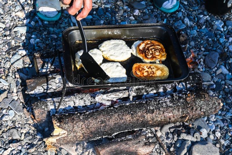 Cooking Pancakes on a Fire in Field Conditions. Stock Image - Image of ...