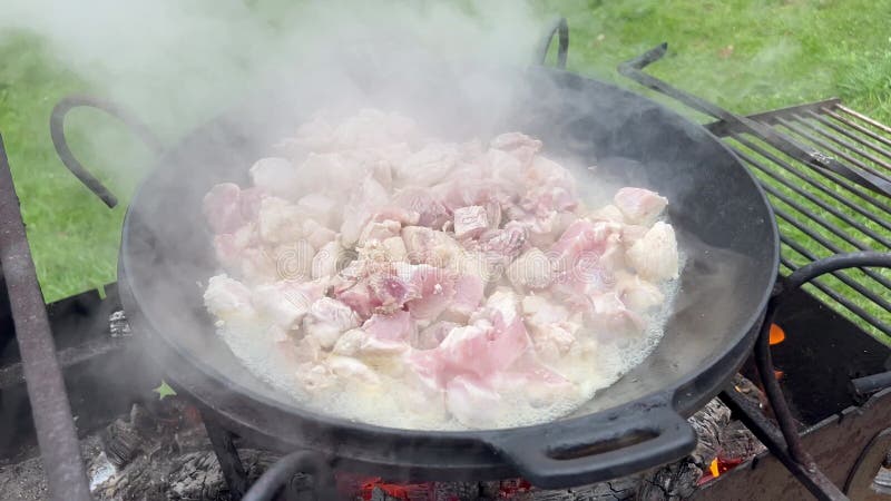 Cooking Pilaf on a Fire in Cauldron, Meat is Fried. Stock Footage ...