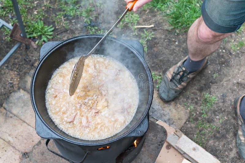 Cooking in a Large Cauldron in Nature Stock Photo - Image of cooking ...