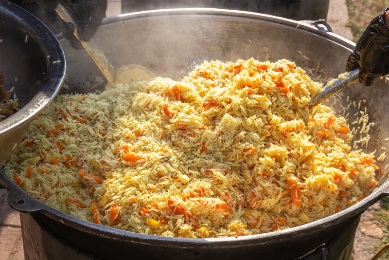 Cooking Pilaf in a Large Cauldron Over an Open Fire. Stock Photo ...