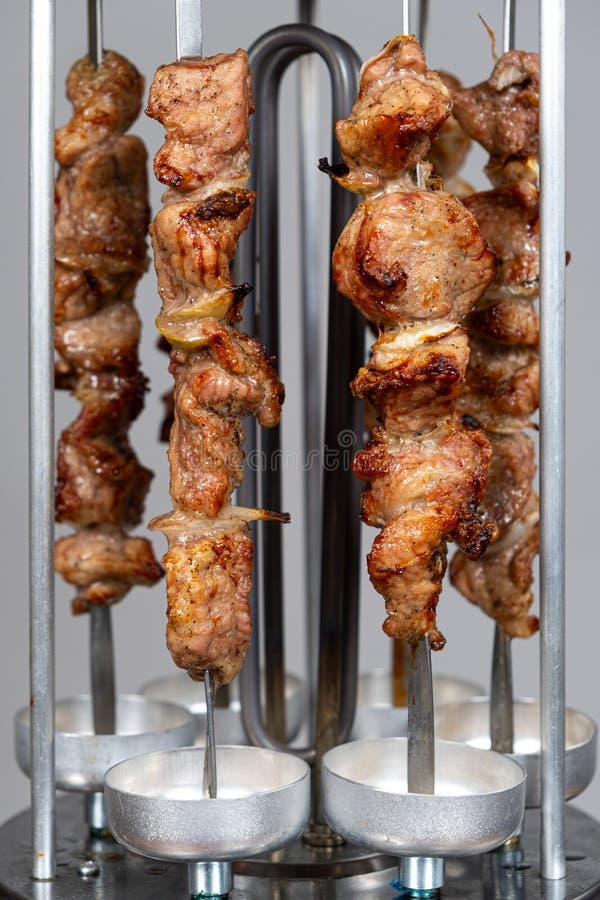 Cooking Pork Meat in an Electric Kebab Maker on Vertical Skewers Stock ...