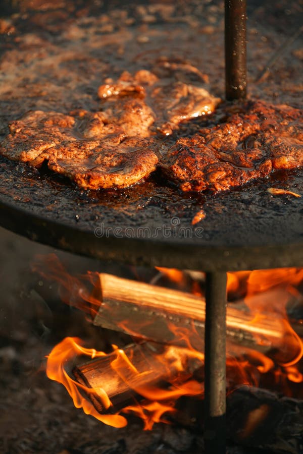 Cooking Pork Meat Over the Fire by the Jar on a Disk Stock Photo ...