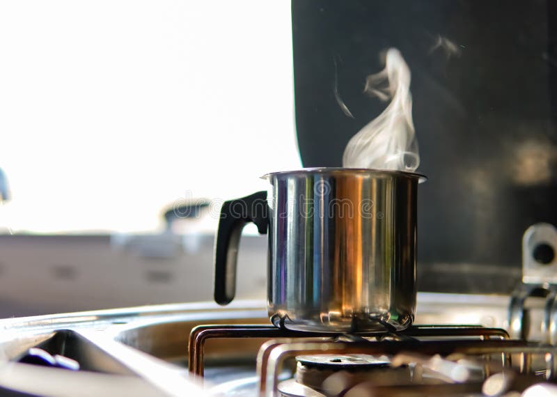 Cooking Pot Boiling Water in the Kitchen of a Van in Wintertime with ...