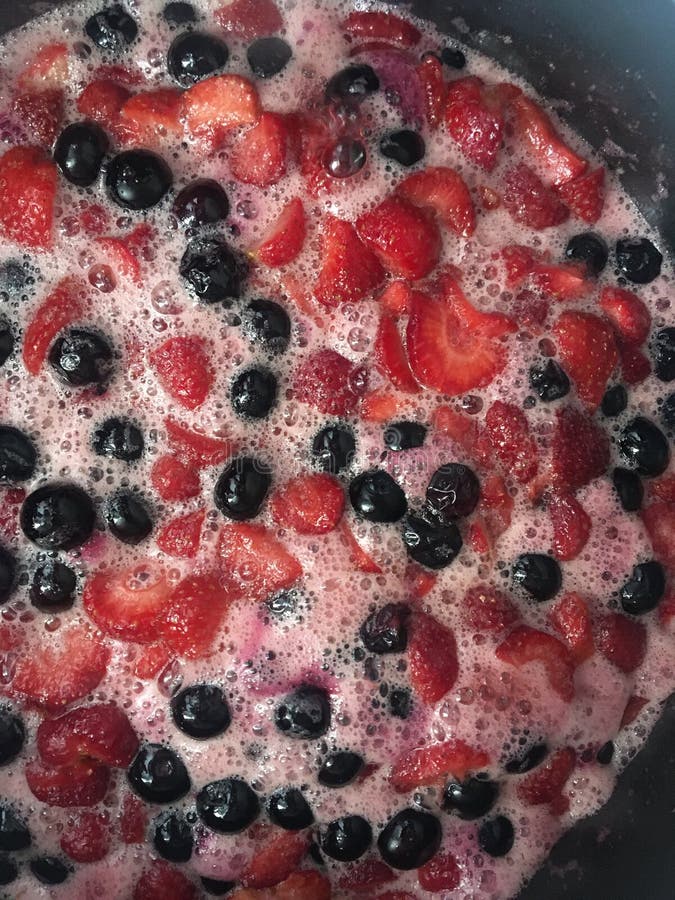 Cooking a red fruit jam stock photo. Image of natural - 233629926