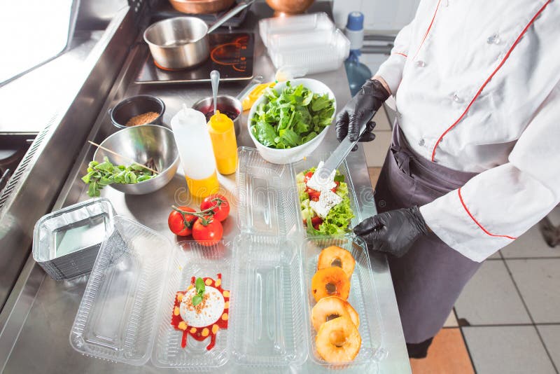 Cooking in a Restaurant and Packing in a Container for Delivery Stock ...