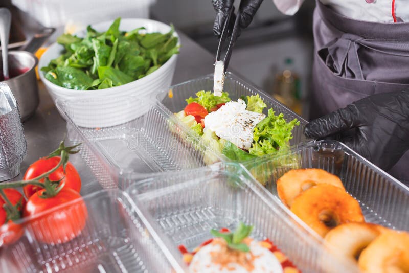 Cooking in a Restaurant and Packing in a Container for Delivery Stock ...