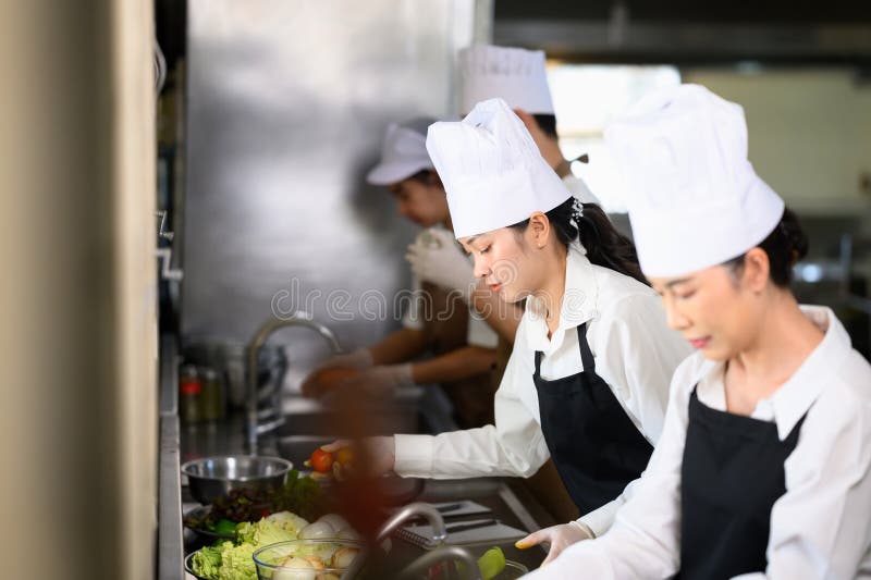 Cooking School Students Preparing Fresh Ingredients during Class Stock ...