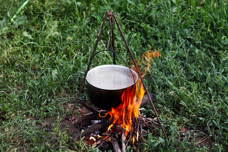 Cooking soup on a fire stock image. Image of camping - 187160229