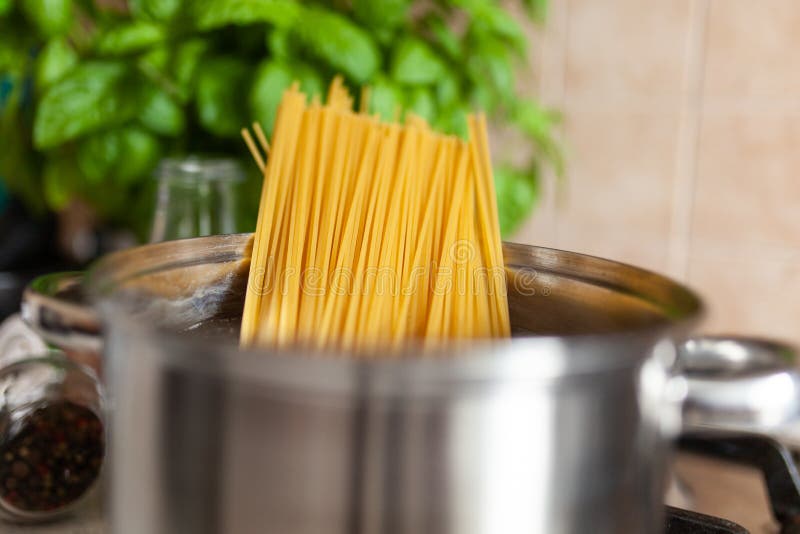 Cooking spaghetti in a pot stock photo. Image of ingredient - 124328814