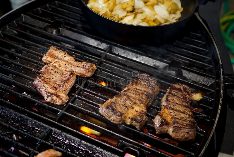 Cooking Steak Beef on Black BBQ Grills. Stock Image - Image of steak ...