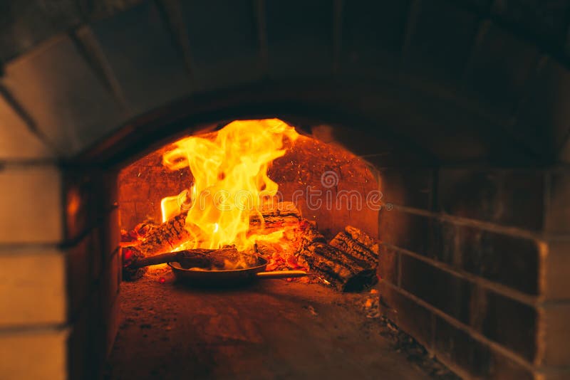 Cooking Steak in a Stone Oven. Chef Pepper the Steak on Fire. Stock ...