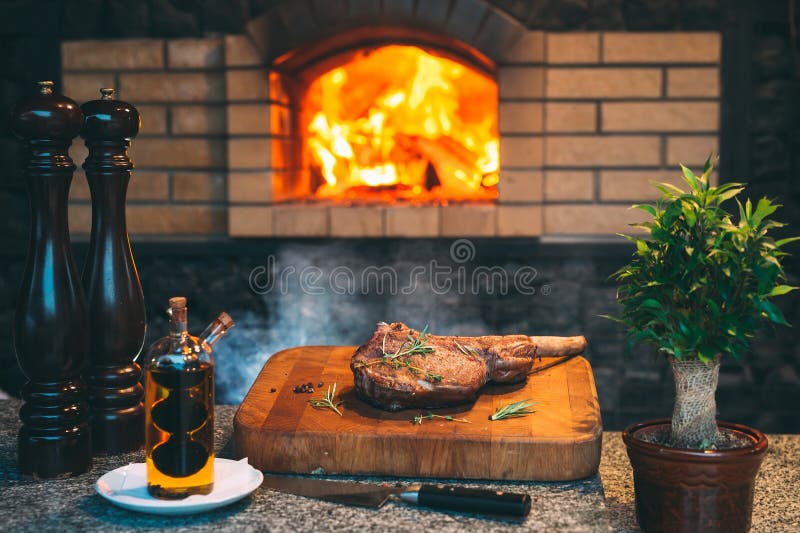 Cooking Steak with a Fire in a Stone Oven. Stock Photo - Image of ...