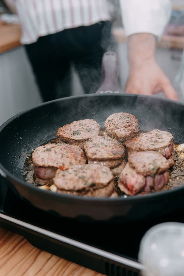Cooking Steaks in a Frying Pan. Cooking Beef in a Cooking Master Class ...