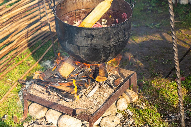 Cooking Pot Over a Burning Fire in Smoke Cooking during Camping Stock ...