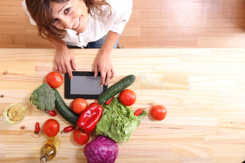 Cooking with a Tablet PC stock image. Image of preparation - 77914837