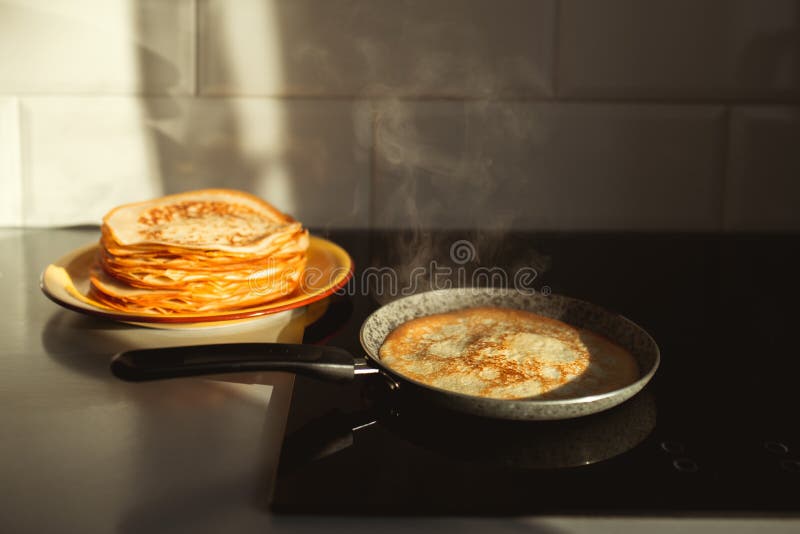 Cooking Thin Pancakes on an Induction Oven Stock Photo - Image of ...