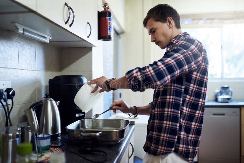 Cooking Up Something in the Kitchen. a Handsome Young Man Cooking in ...