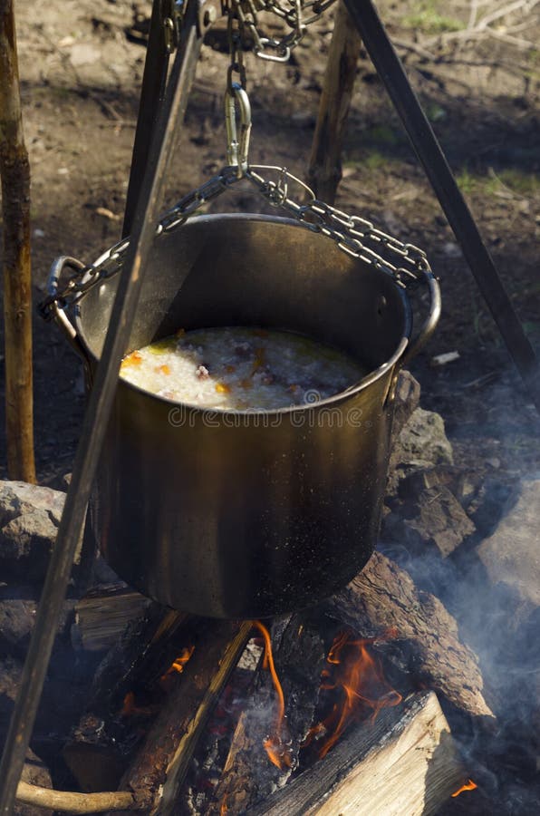 Cooking at the Wood Over Campfire. Casserole with Rice and Meat Stock ...