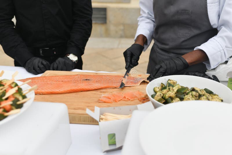 The Cooks Cut Salmon Fish at a Wedding Stock Image - Image of dinner ...