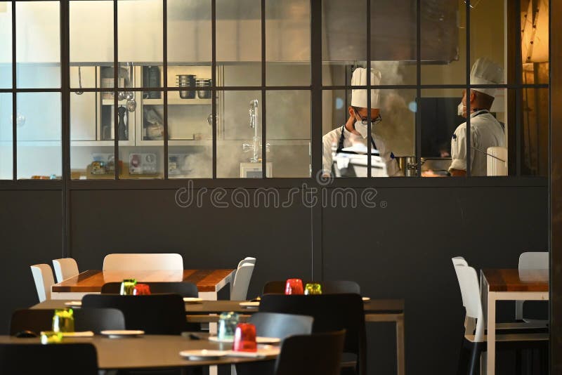 Cooks at Work in the Open Kitchen of a Restaurant before Opening To ...