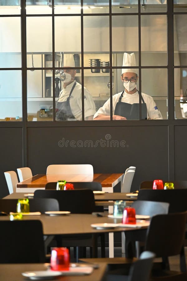 Cooks at Work in the Open Kitchen of a Restaurant before Opening To ...