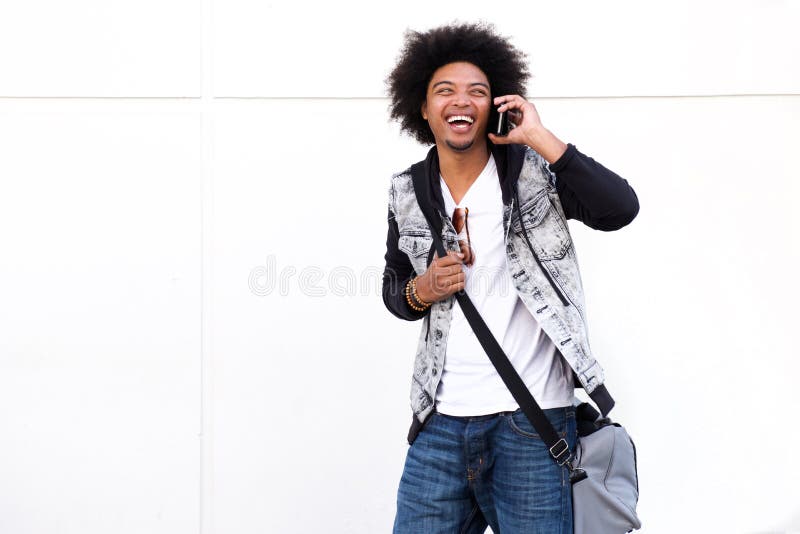 Cool Black Guy Laughing with Mobile Phone and Bag Stock Image - Image ...
