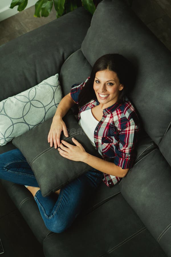 Cool Brunette Girl Sitting on the Sofa Stock Photo - Image of female ...