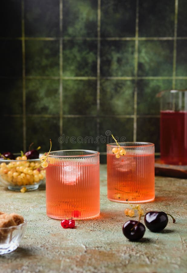 Cool Drink, Compote of Various Berries in Glasses with Ice on a Green ...