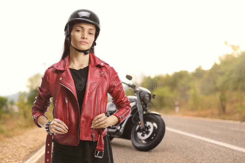 Cool Female Biker with a Helmet Standing and Posing on a Road Stock ...