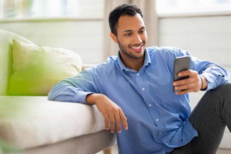 Portrait of Smiling Arab Man Using Smartphone at Home Stock Image ...