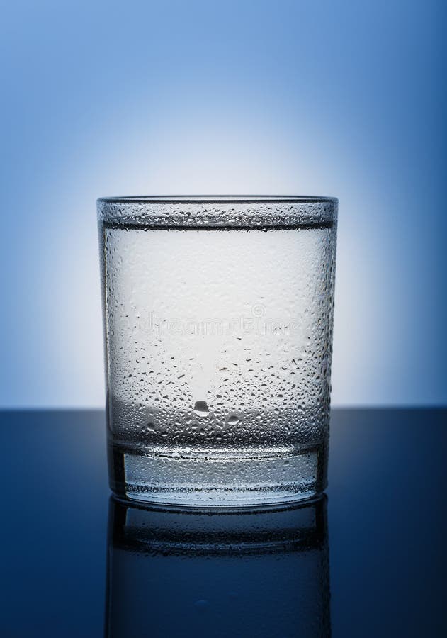 Cool Glass of Pure Water on a Blue Background Stock Image - Image of ...