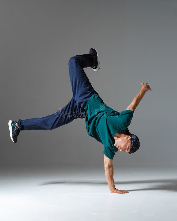 Stylish Young Guy Breakdancer Dances Hip Hop on the Floor in Studio ...