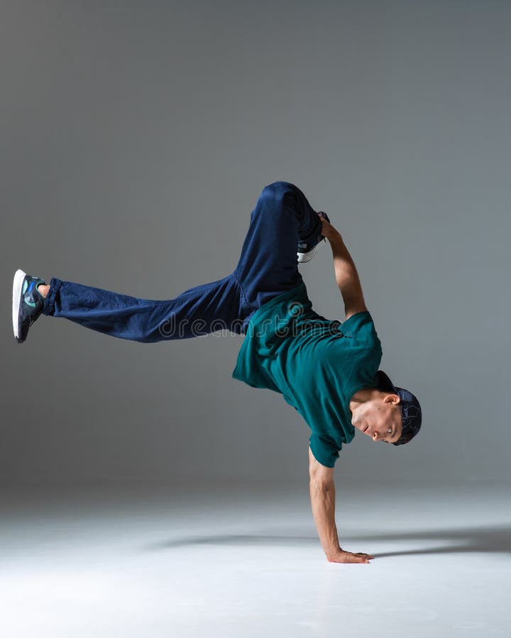 Cool B-boy Dancing on One Hand in Studio Isolated on Gray Background ...