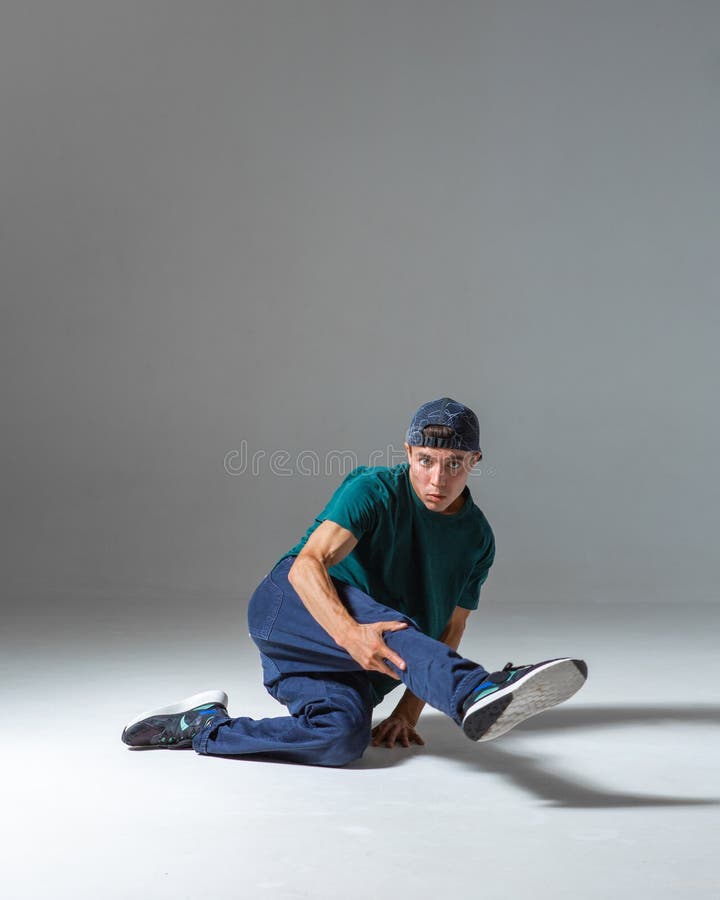 Stylish Young Guy Breakdancer Dances Hip Hop on the Floor in Studio ...