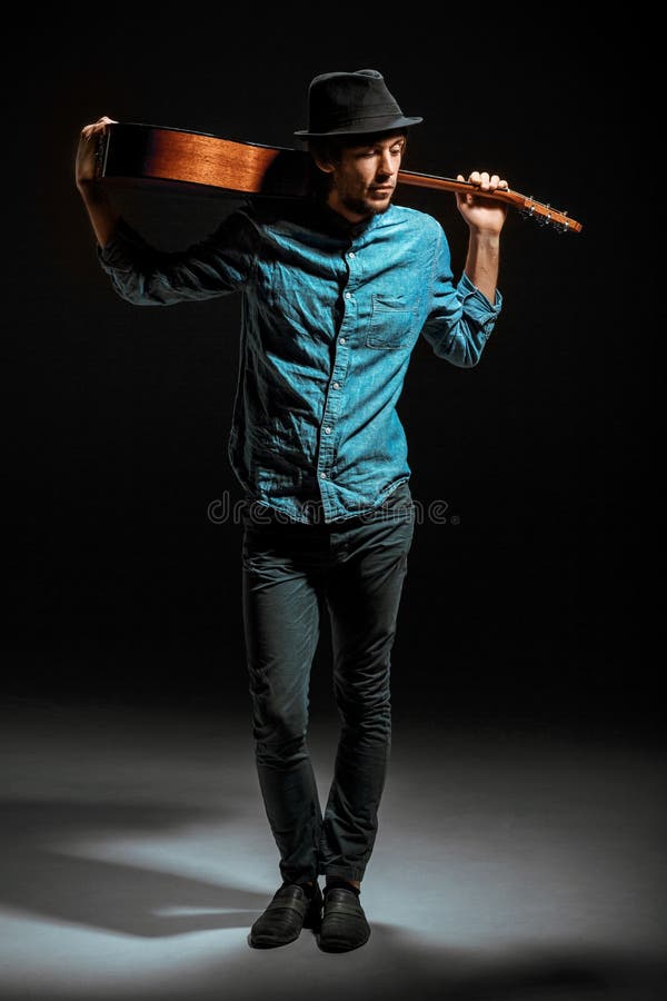Cool Guy Standing with Guitar on Dark Background Stock Photo - Image of ...